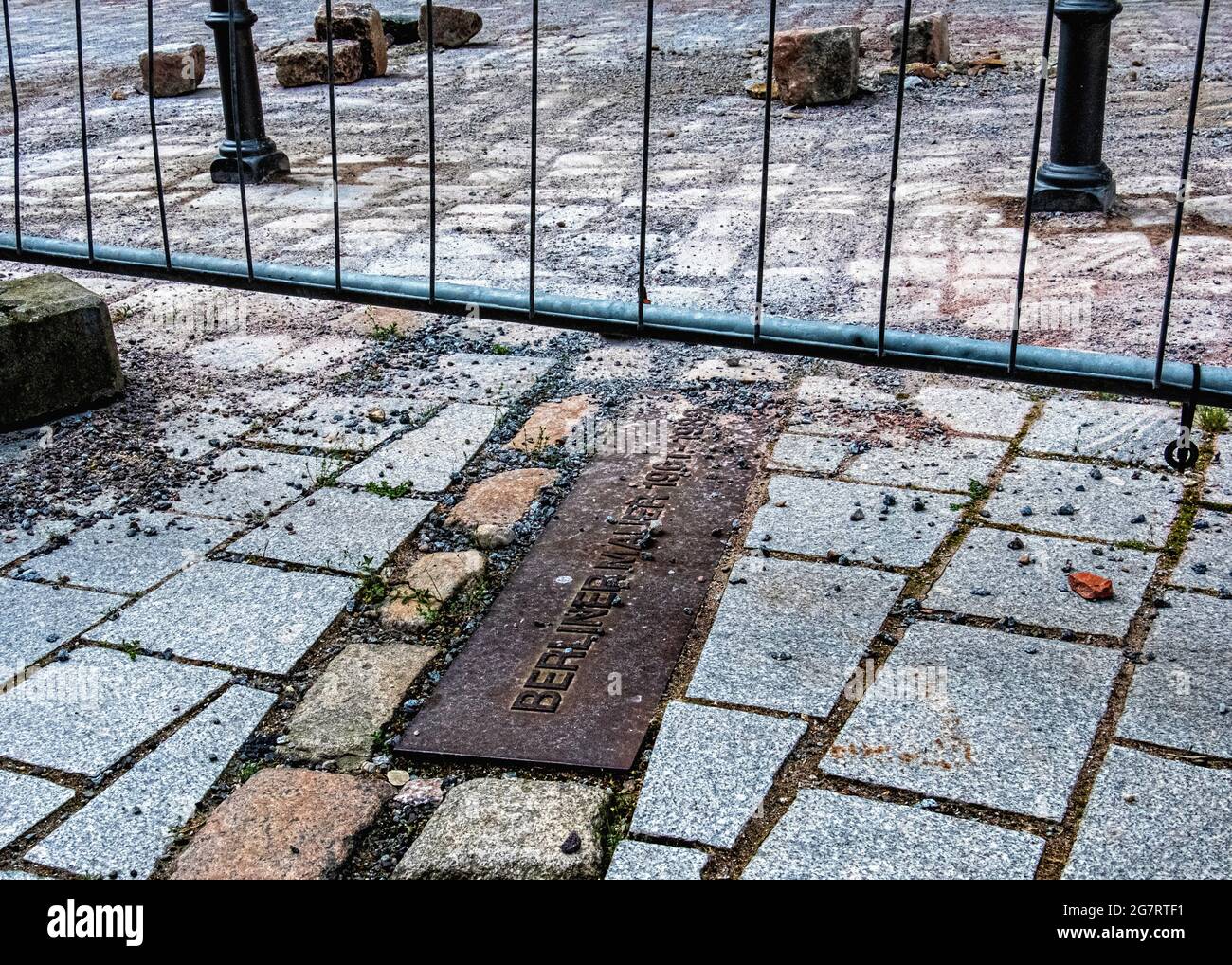 Cobblestones & Plaque marking site of Berlin Wall emerge form fenced ...