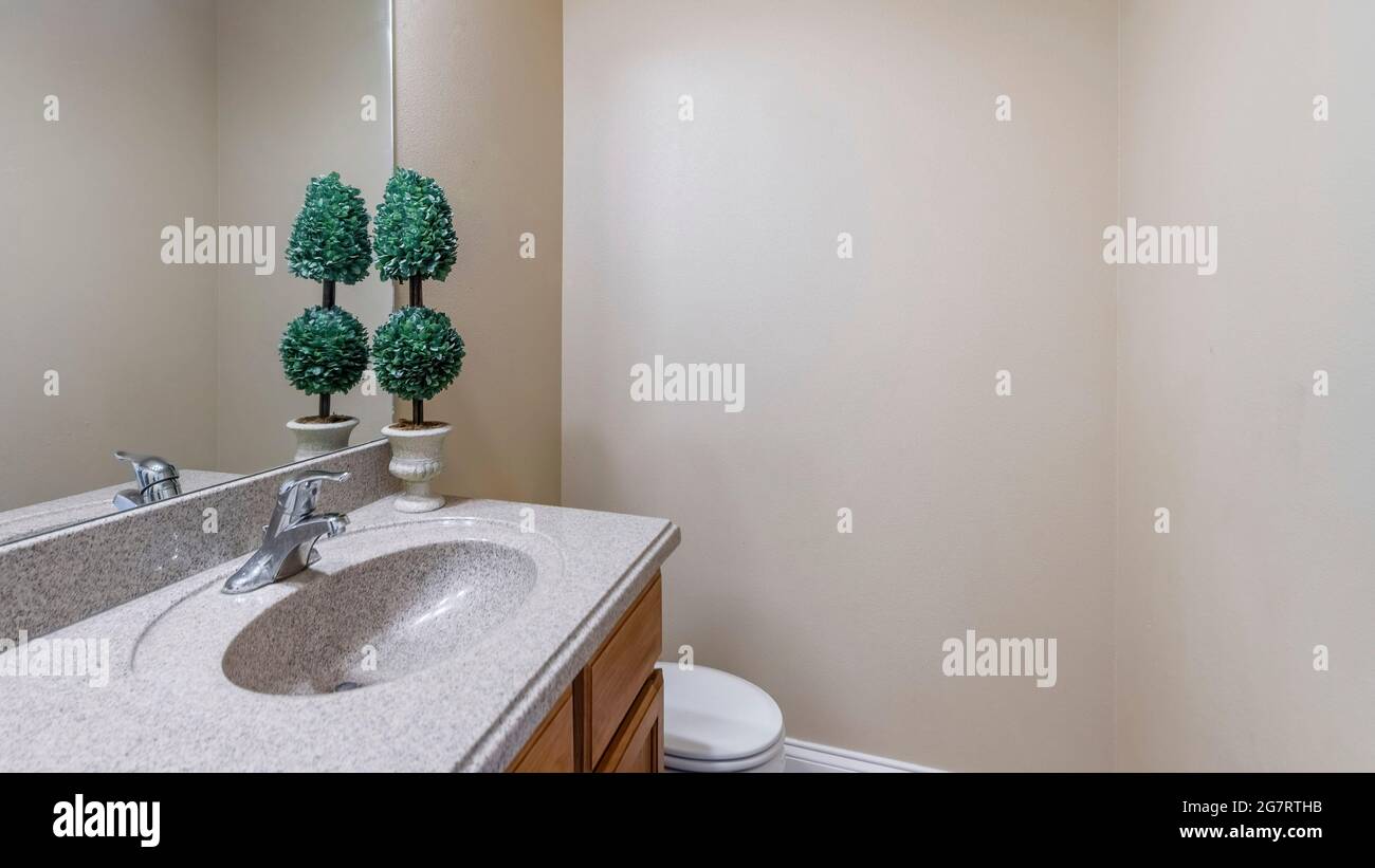 Pano Interior of a plain bathroom with vanity sink and toilet bowl ...