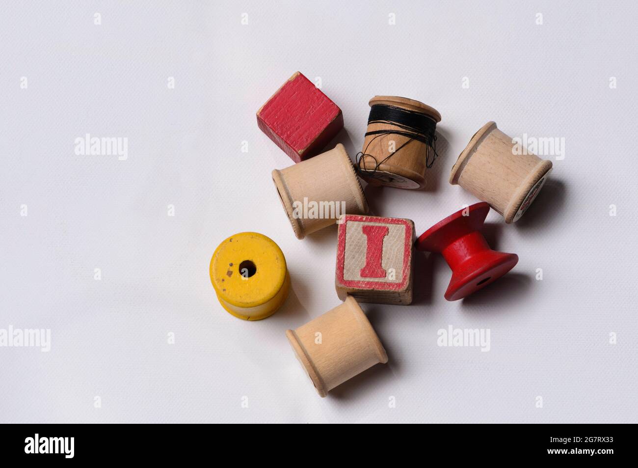 Vintage wooden spools and blocks on white background Stock Photo - Alamy