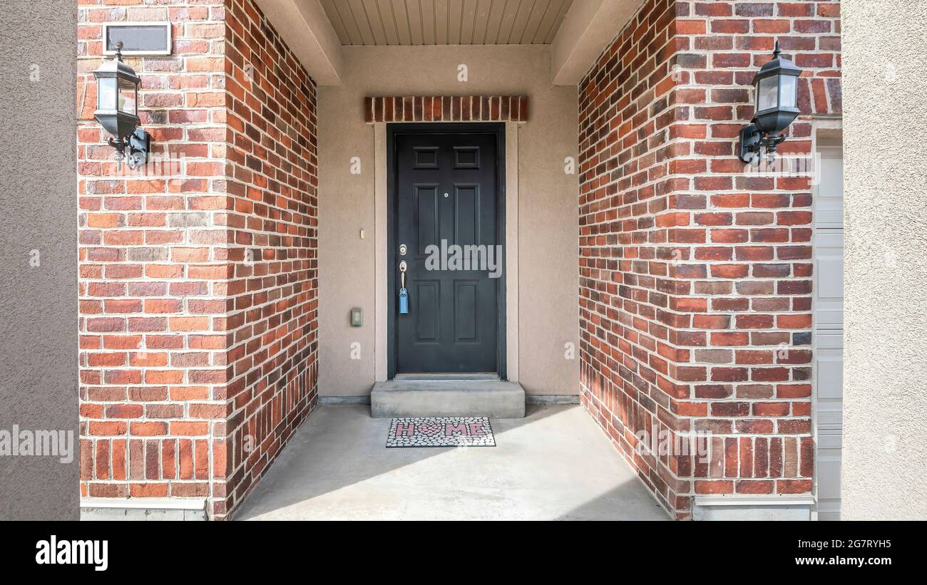 Pano Front door entrance exterior in the middle of red brick walls ...
