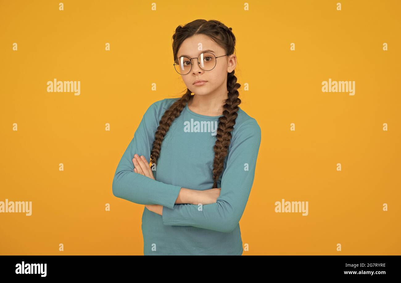 having vision problems. serious child with long hairdo. teen has bad ...