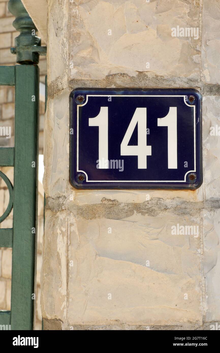 Close-up Of House Number On The Stone Wall And A Part Of The Green ...