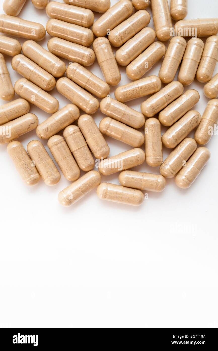 Brown capsule pills on white isolated background Stock Photo - Alamy