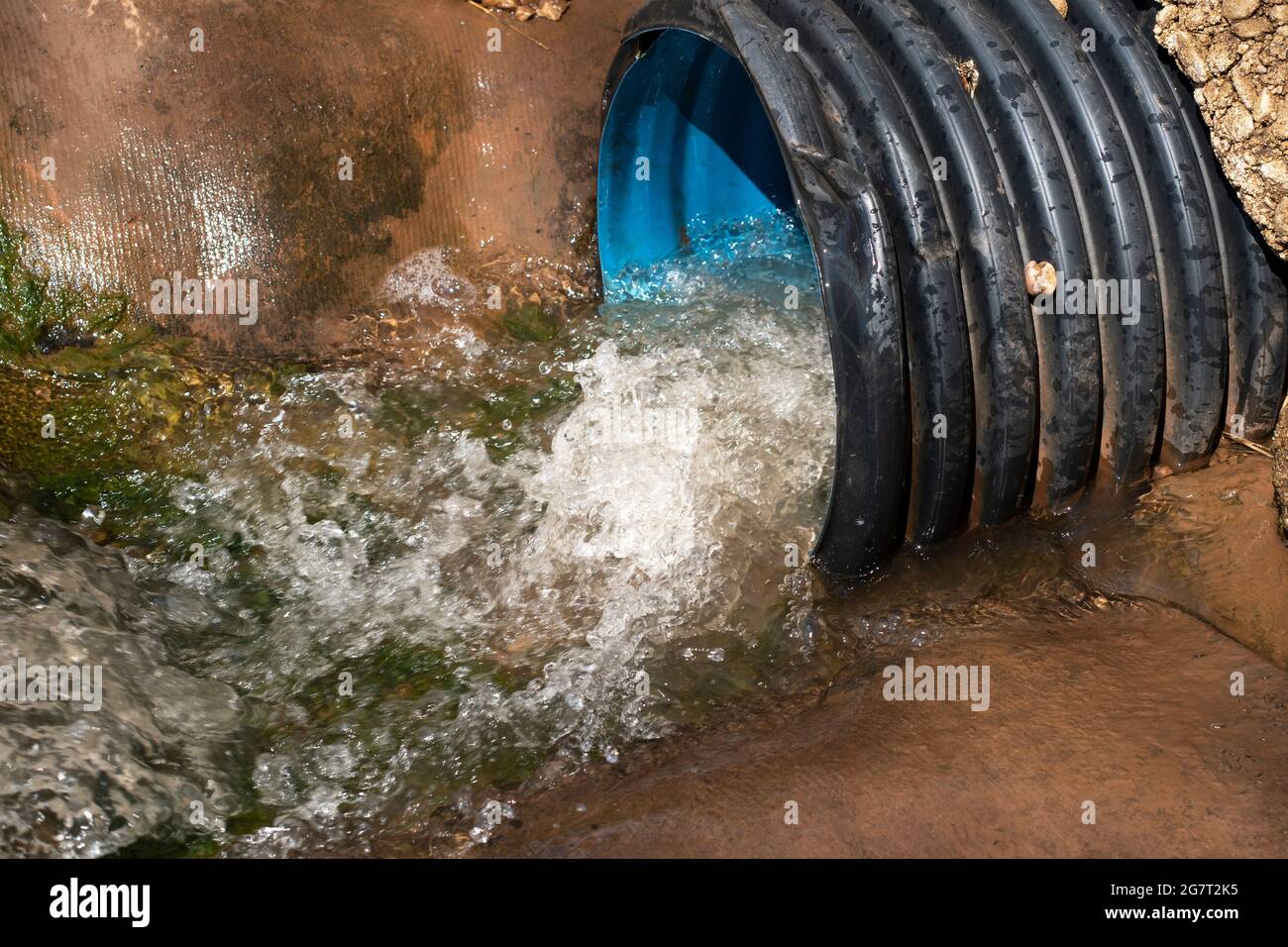 Water gushing out of a plastic sewer pipe Stock Photo - Alamy