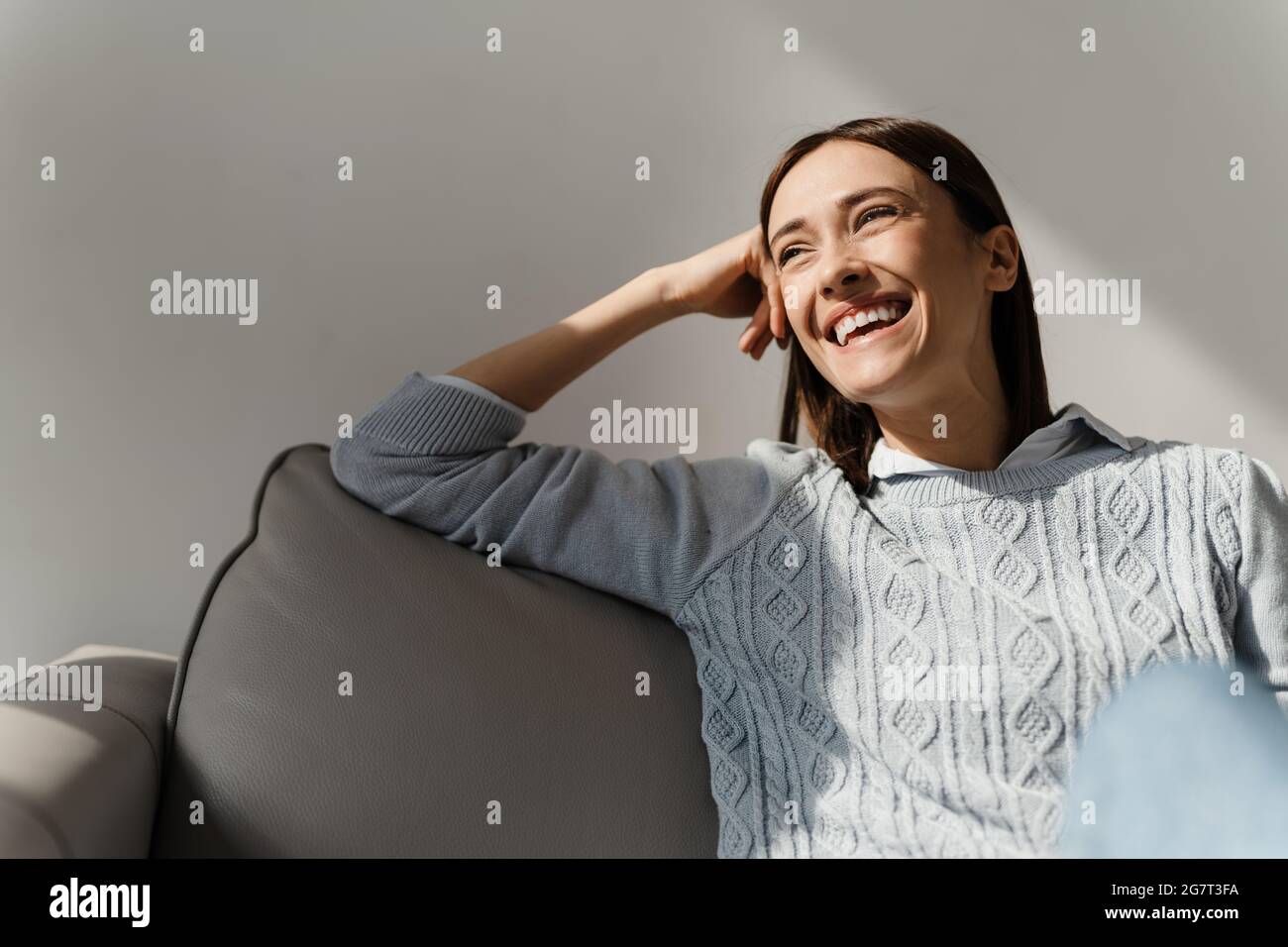 Smiling happy middle aged woman relaxing on a couch at home Stock Photo ...