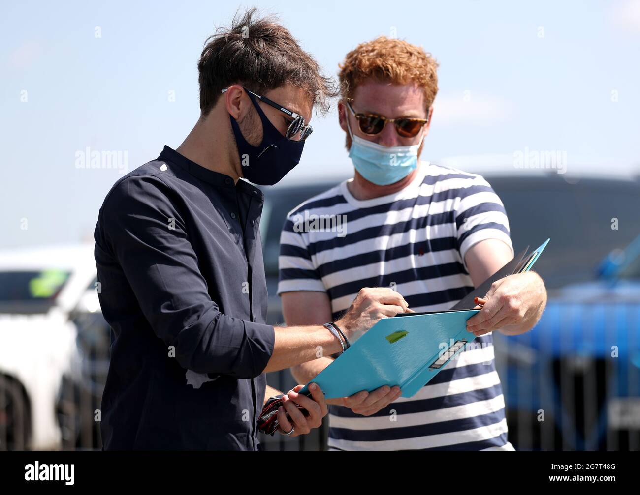 AlphaTauri's Pierre Gasly signs an autograph for a fan as he arrives ...