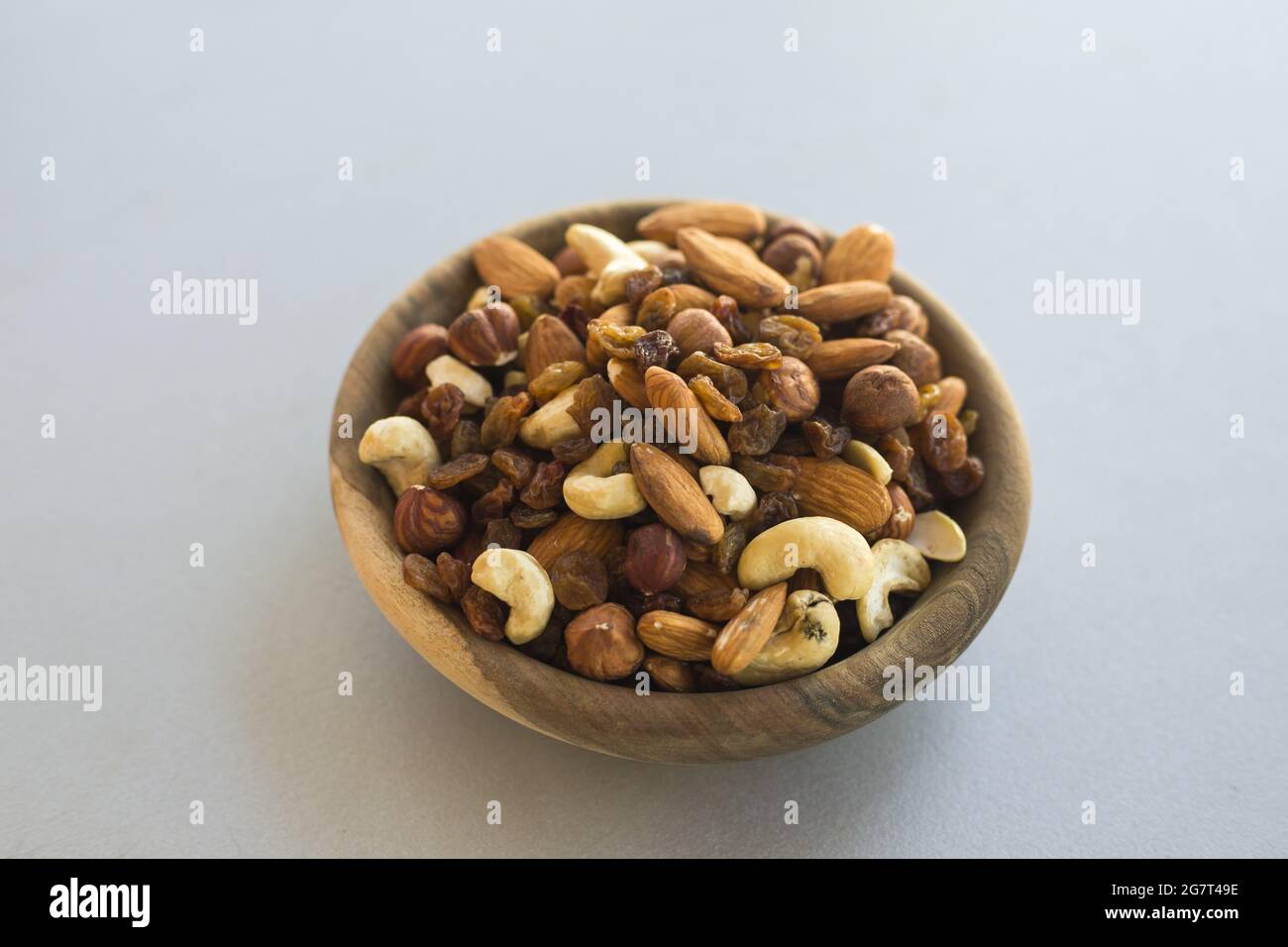 Photo of a different types of nuts in a plate on a gray table Stock ...