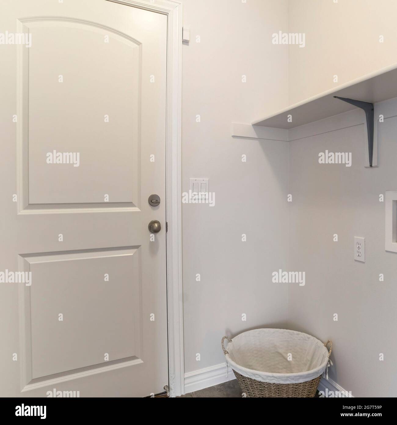 Square frame Interior of a laundry room with shelf and woven basket ...