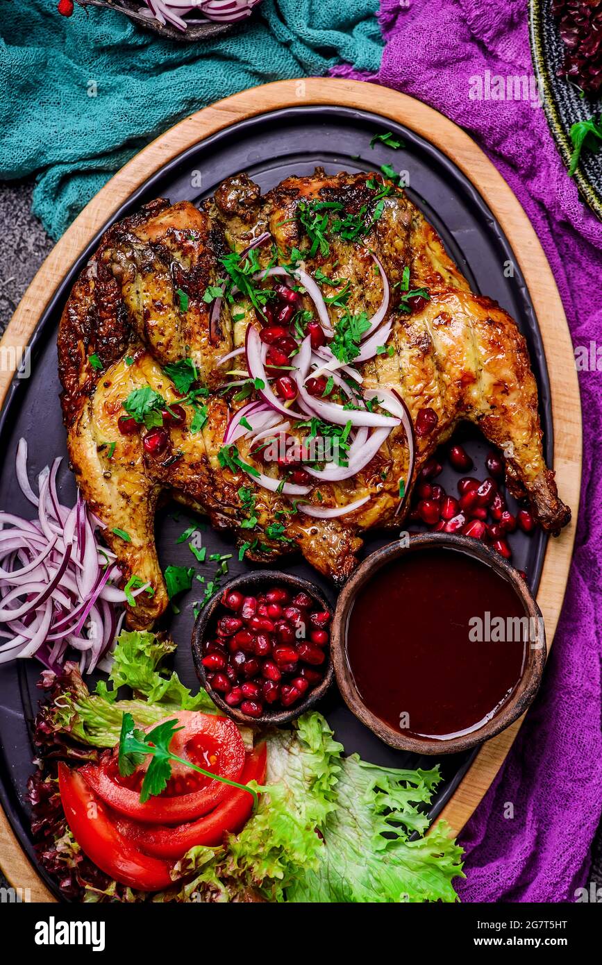 Chicken Tabaka.traditional Georgian dish ..style rustic.selective focus ...