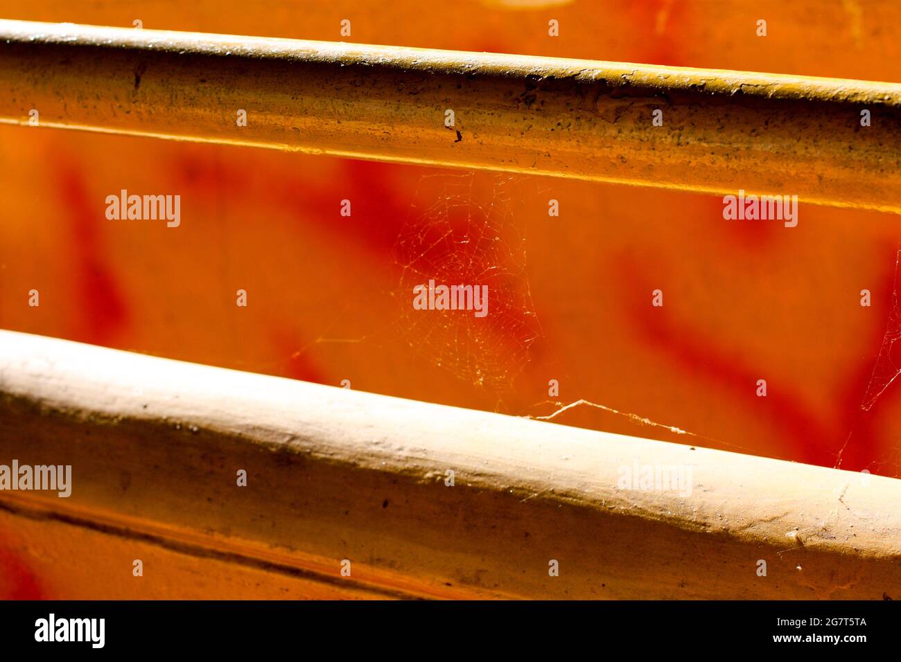 Closeup of a spider web between two old pipes Stock Photo - Alamy