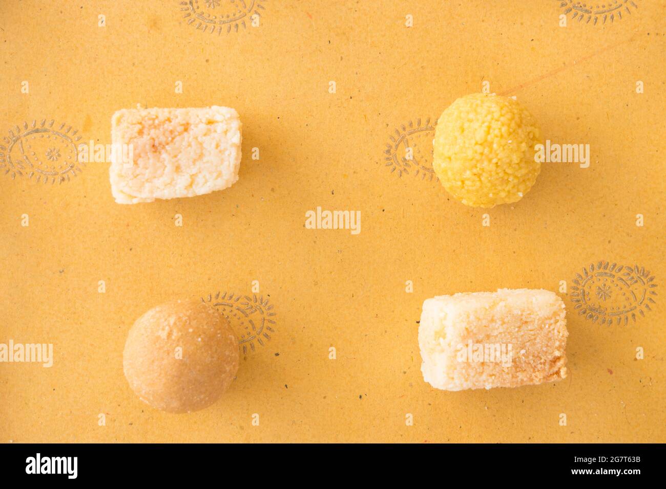 Top view of Indian sweets for Diwali, on a yellow surface Stock Photo ...