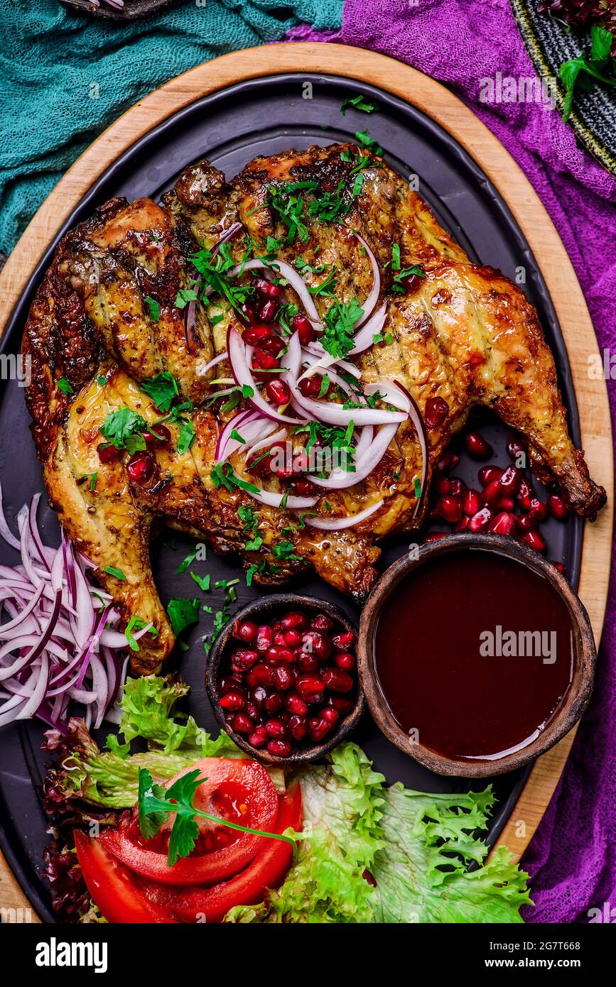 Chicken Tabaka.traditional Georgian dish ..style rustic.selective focus ...
