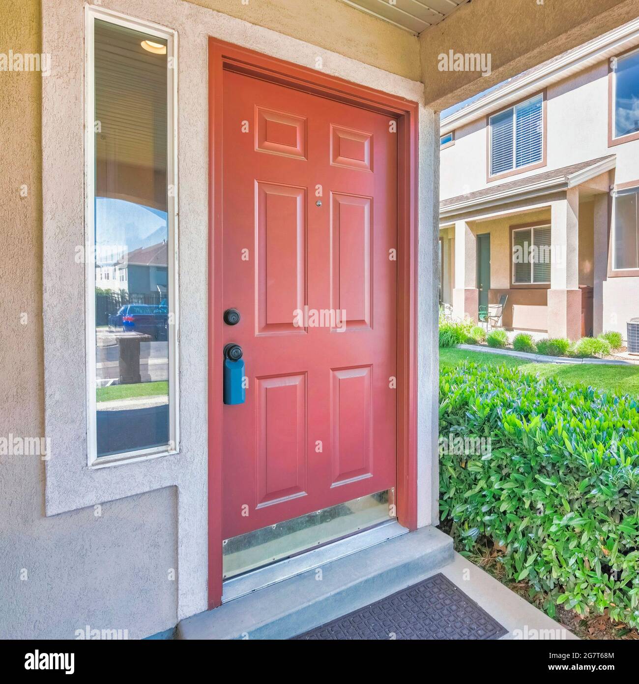 Square frame Lockbox on closed and secured brown wooden front door of a ...