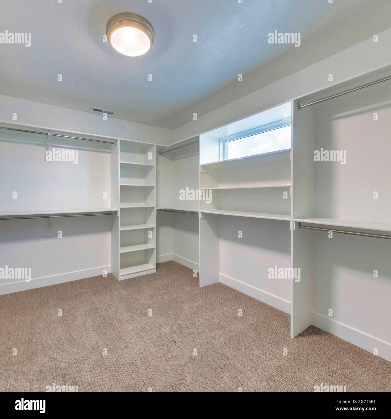 Square frame Walk in closet of house with empty built in shelves and ...