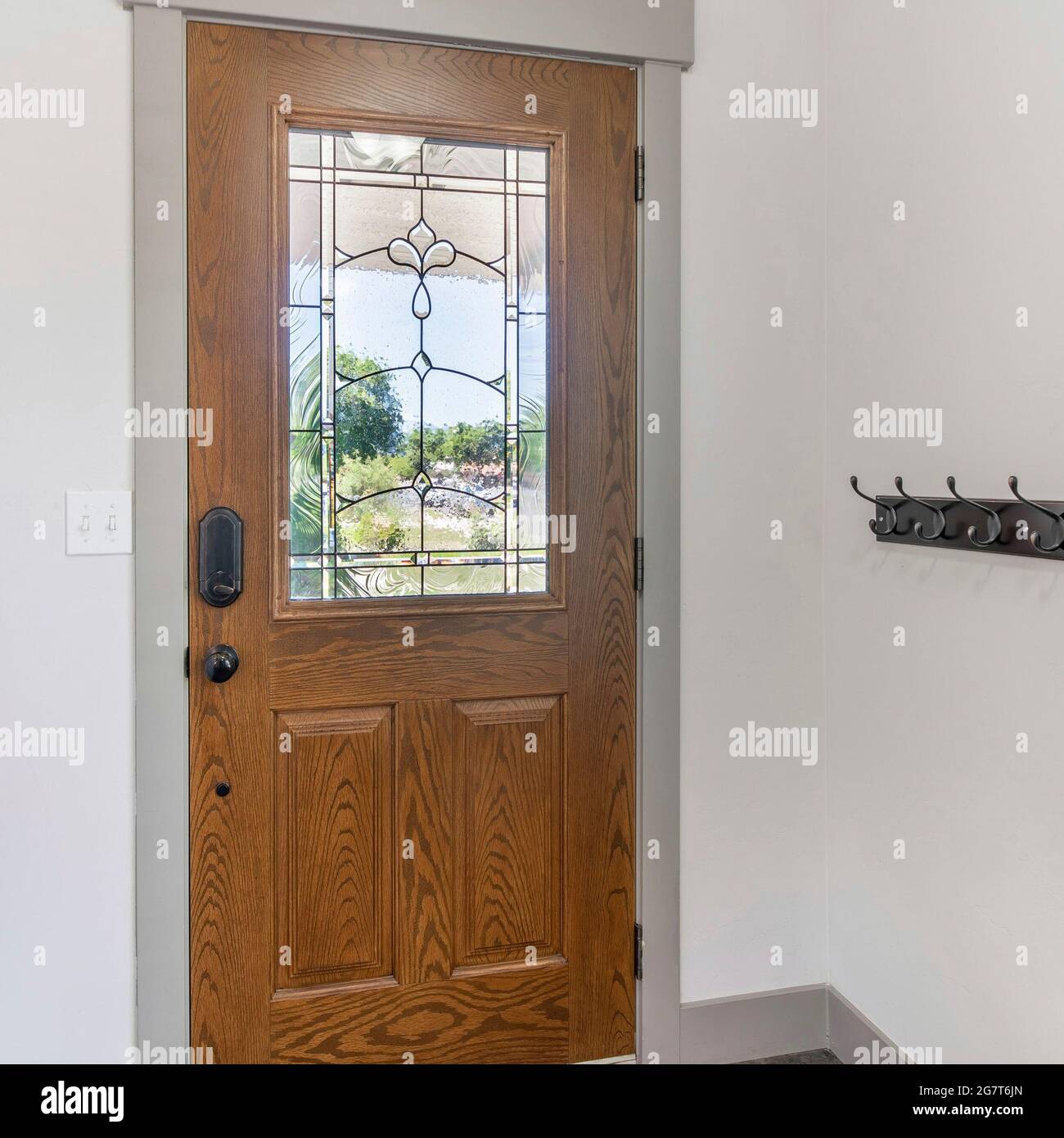 Square frame Interior of a front door with wall rail-mounted hanging ...