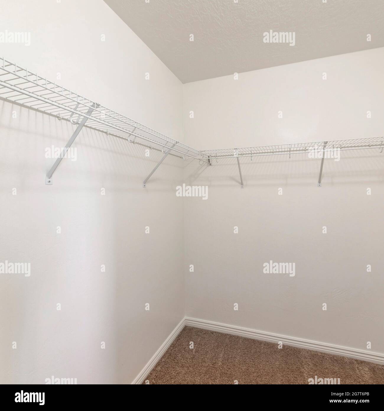 Square frame Empty storage room with wall mounted white metal shelves ...