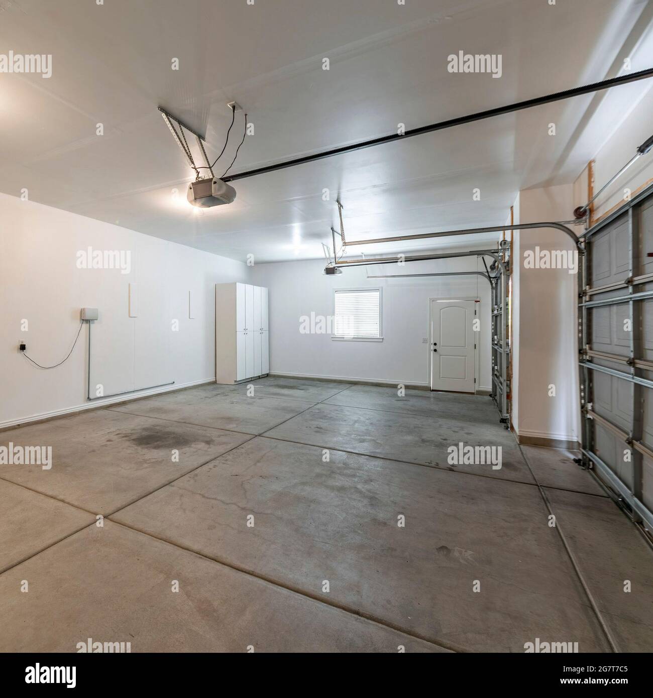 Square frame Interior of a garage with double automatic doors and ...