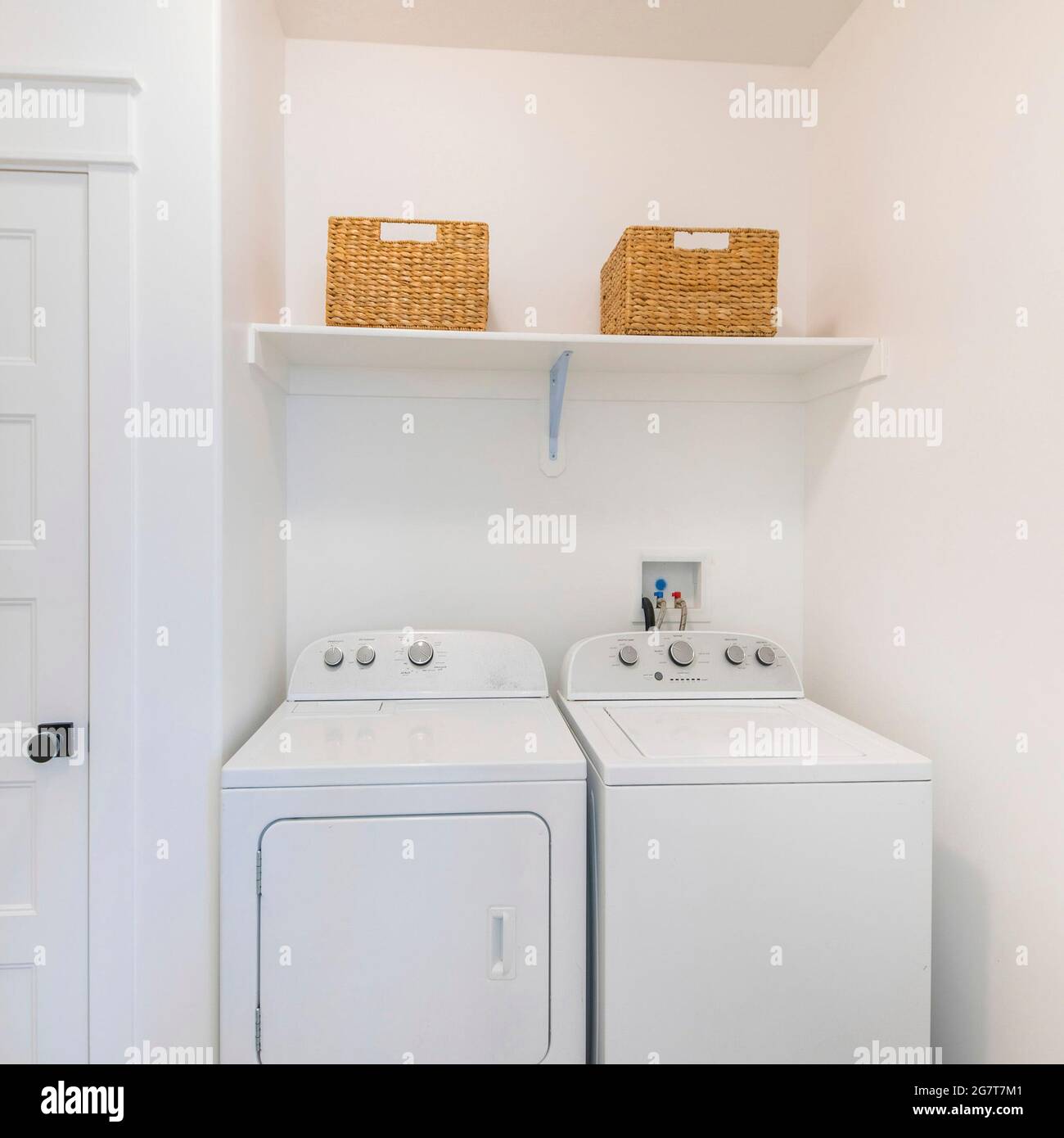 Square frame Small white laundry room interior with washer and dryer ...