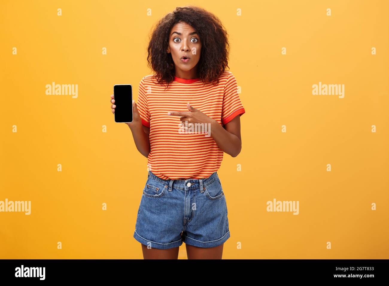 Portrait of impressed and curious female friend showing profile of ex ...