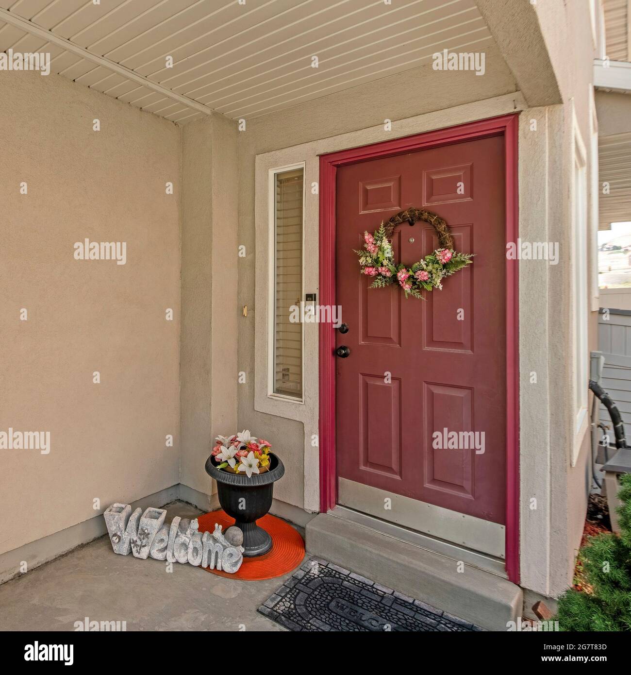 Square frame Front door exterior with decor and bush on the side Stock ...