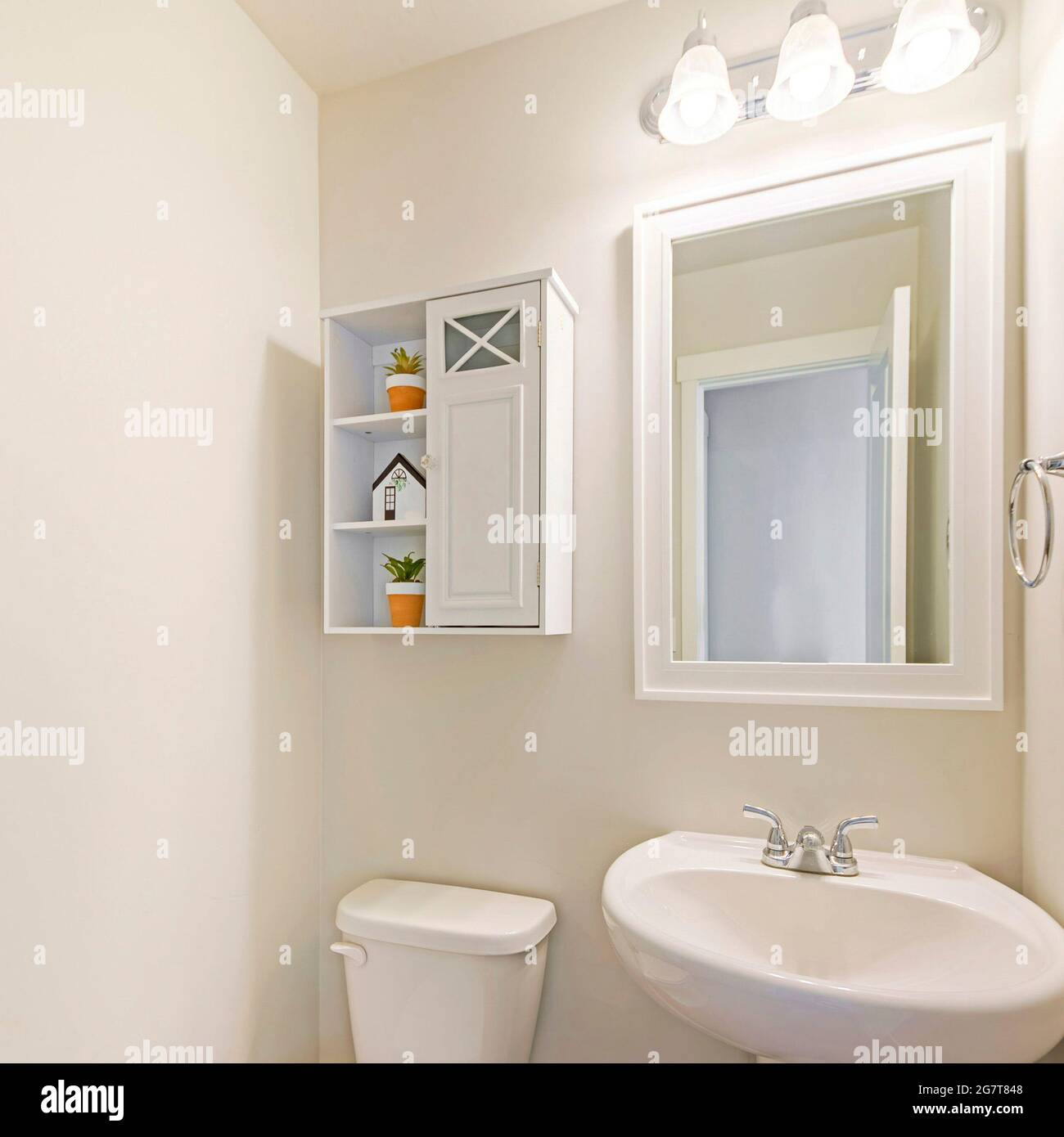 Square frame Interior of a white powder room with minimalist design ...