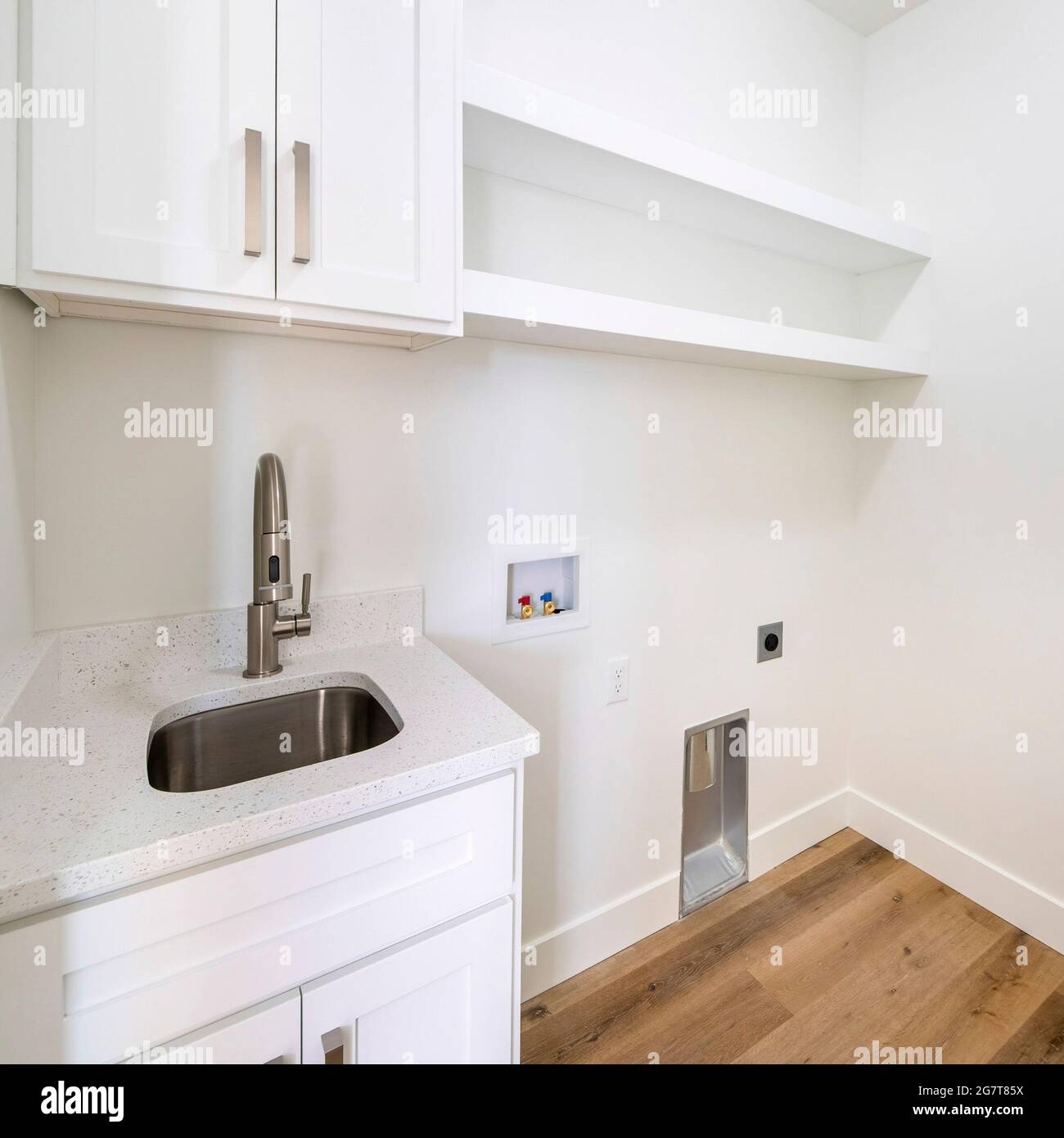 Square frame Empty white laundry room with top storage, laundry ...