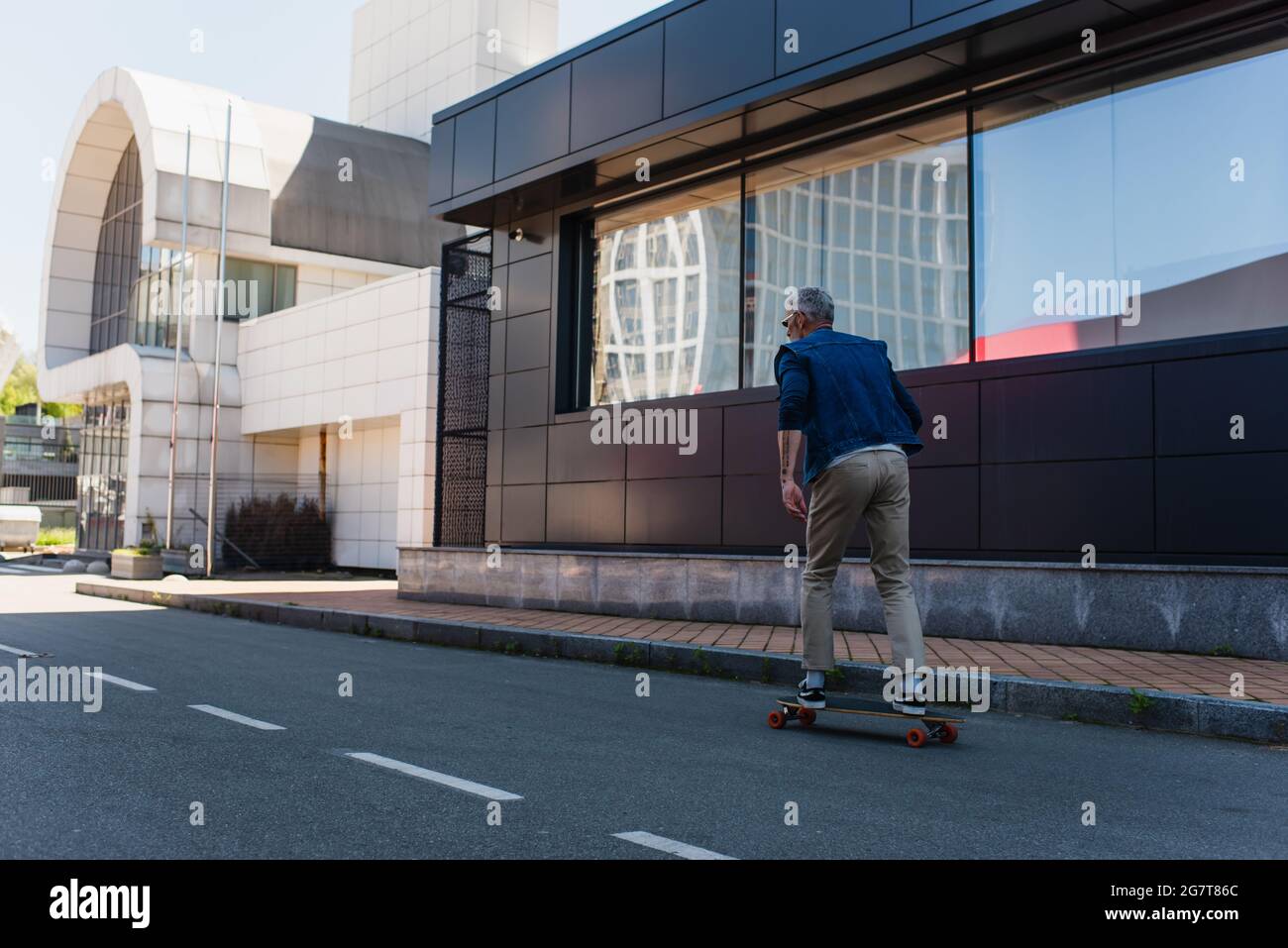 Back view man riding longboard hi-res stock photography and images - Alamy