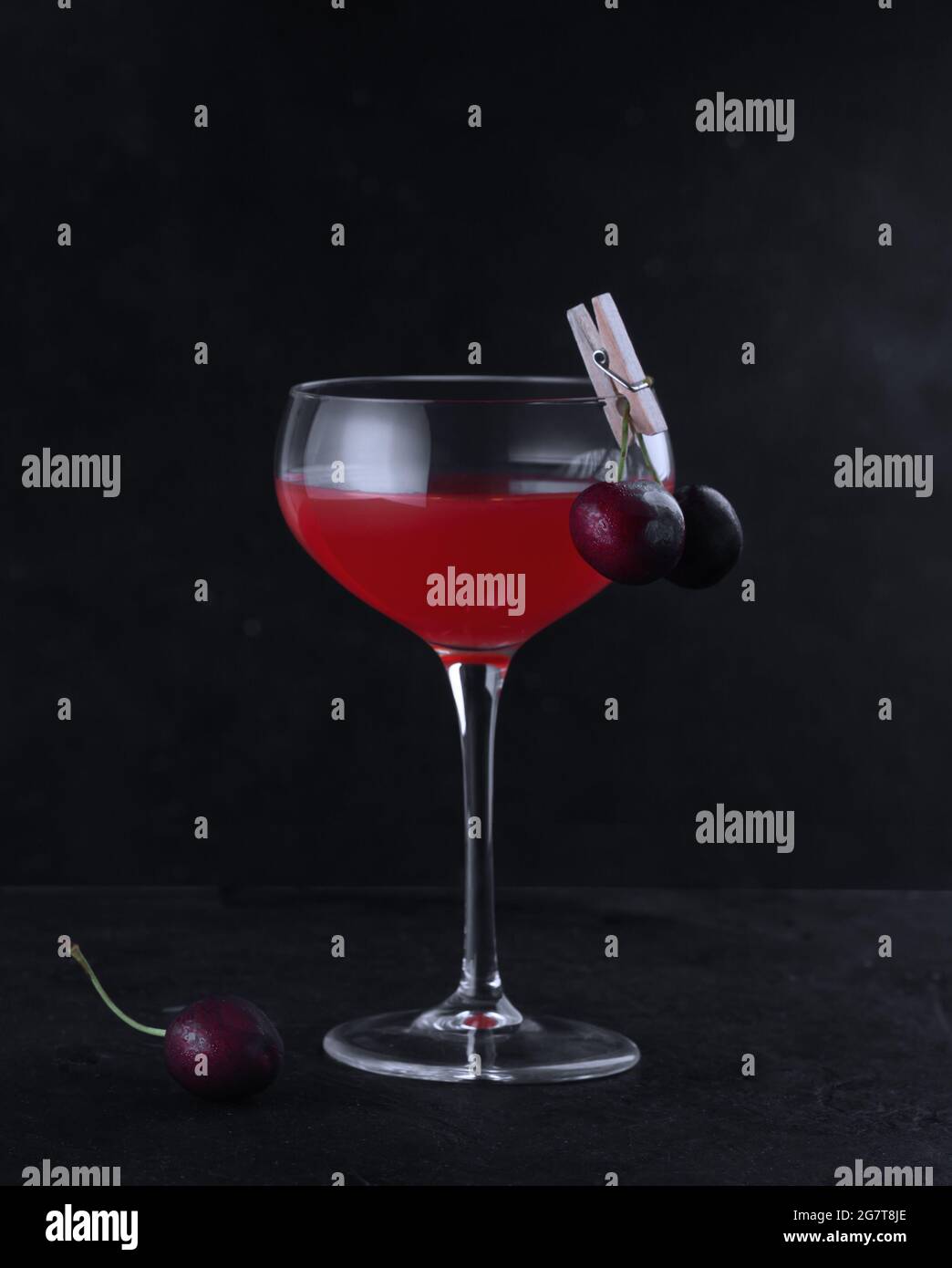 A glass with an alcoholic cocktail made by a bartender decorated with ...