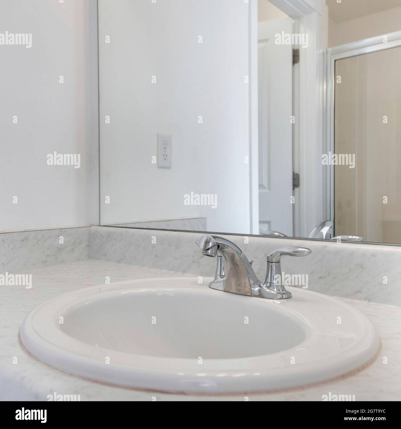 Square frame Single vanity sink with white marble countertop on a white ...