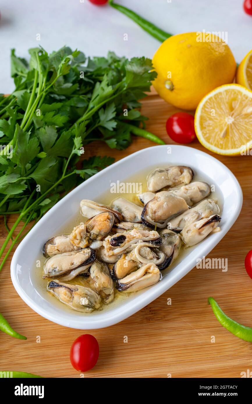 Marinated mussels on wooden background. Seafood dishes Stock Photo - Alamy