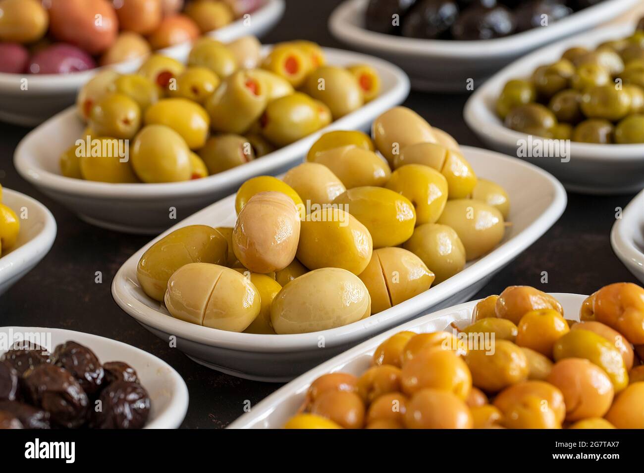 Assortment of olives on the plate in bulk. Organic black olives, Olive ...
