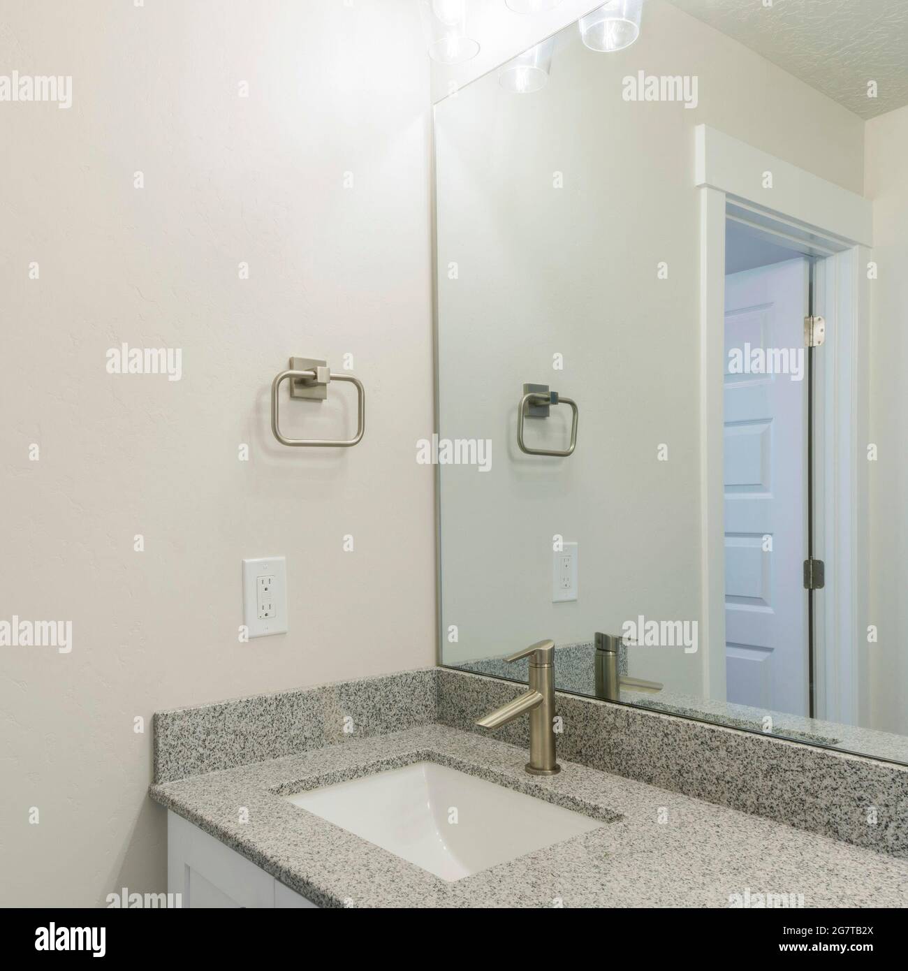 Square frame Vanity sink of a bathroom with granite countertop and wall ...