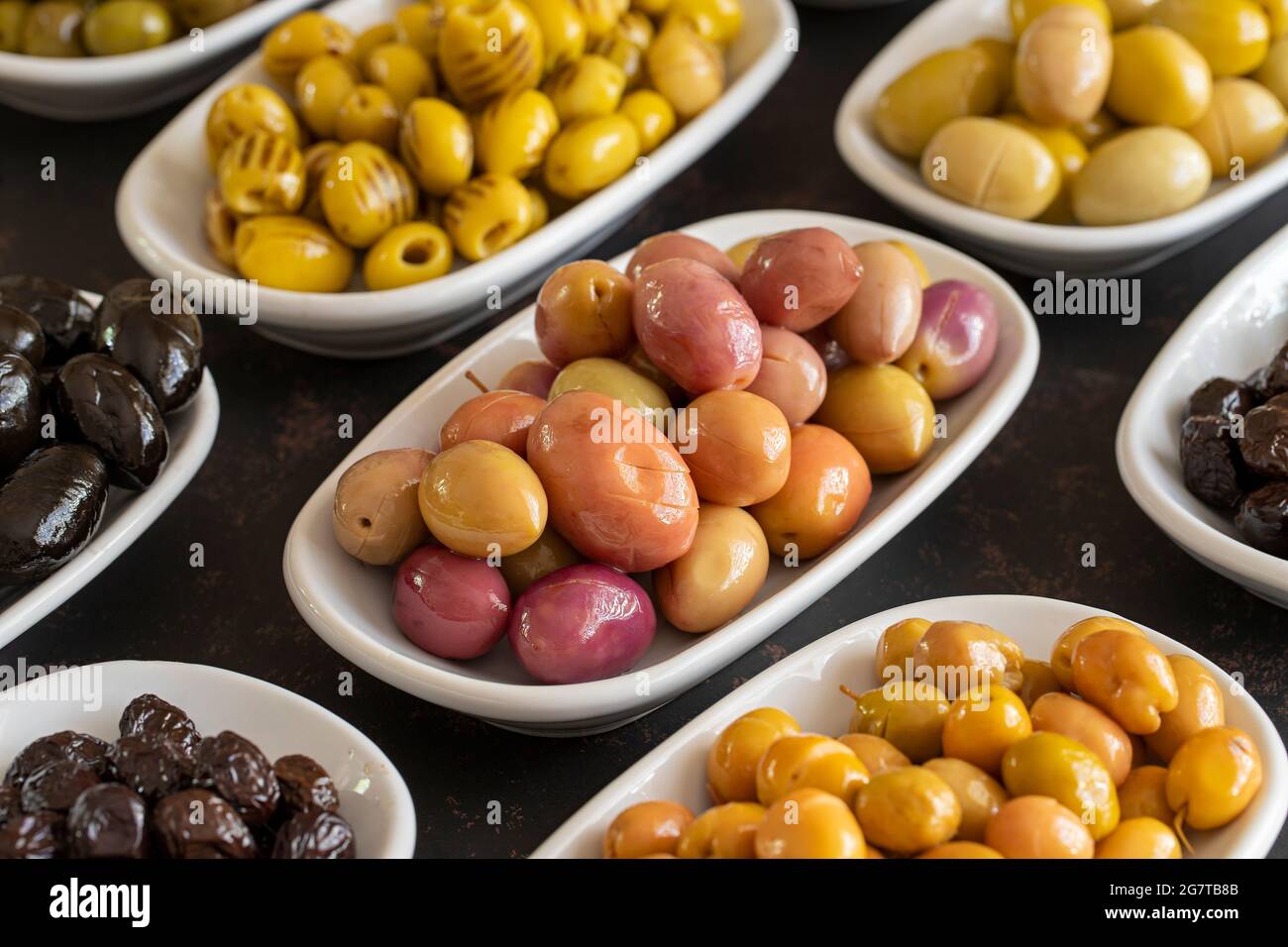 Assortment of olives on the plate in bulk. Organic black olives, Olive ...