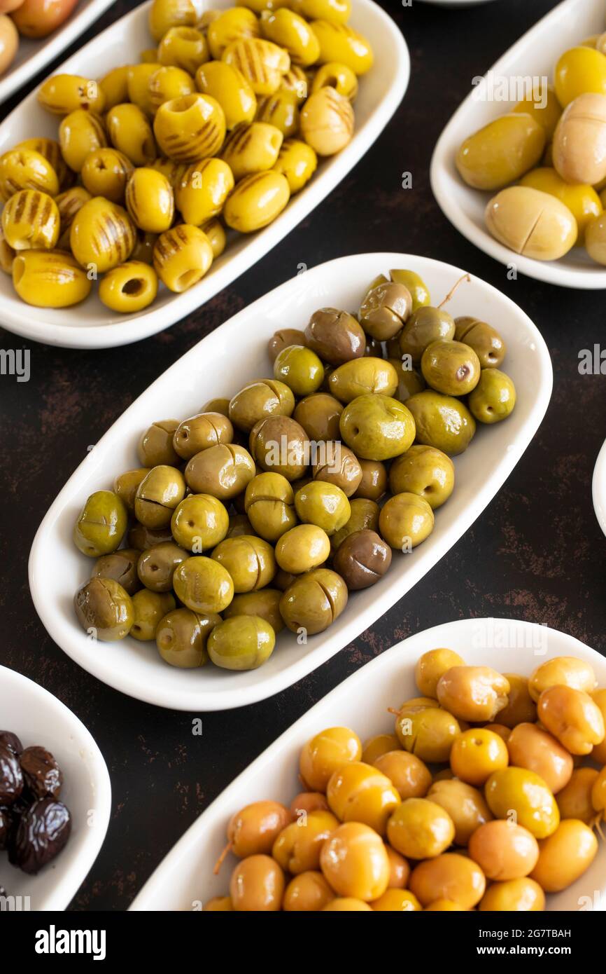 Assortment of olives on the plate in bulk. Organic black olives, Olive ...