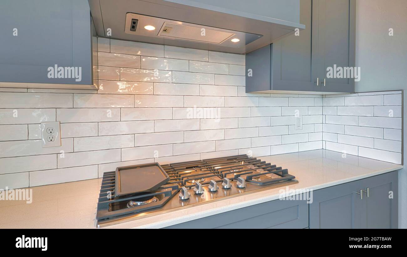 Pano Cooktop stove fixed on kitchen countertop with exhaust hood and ...