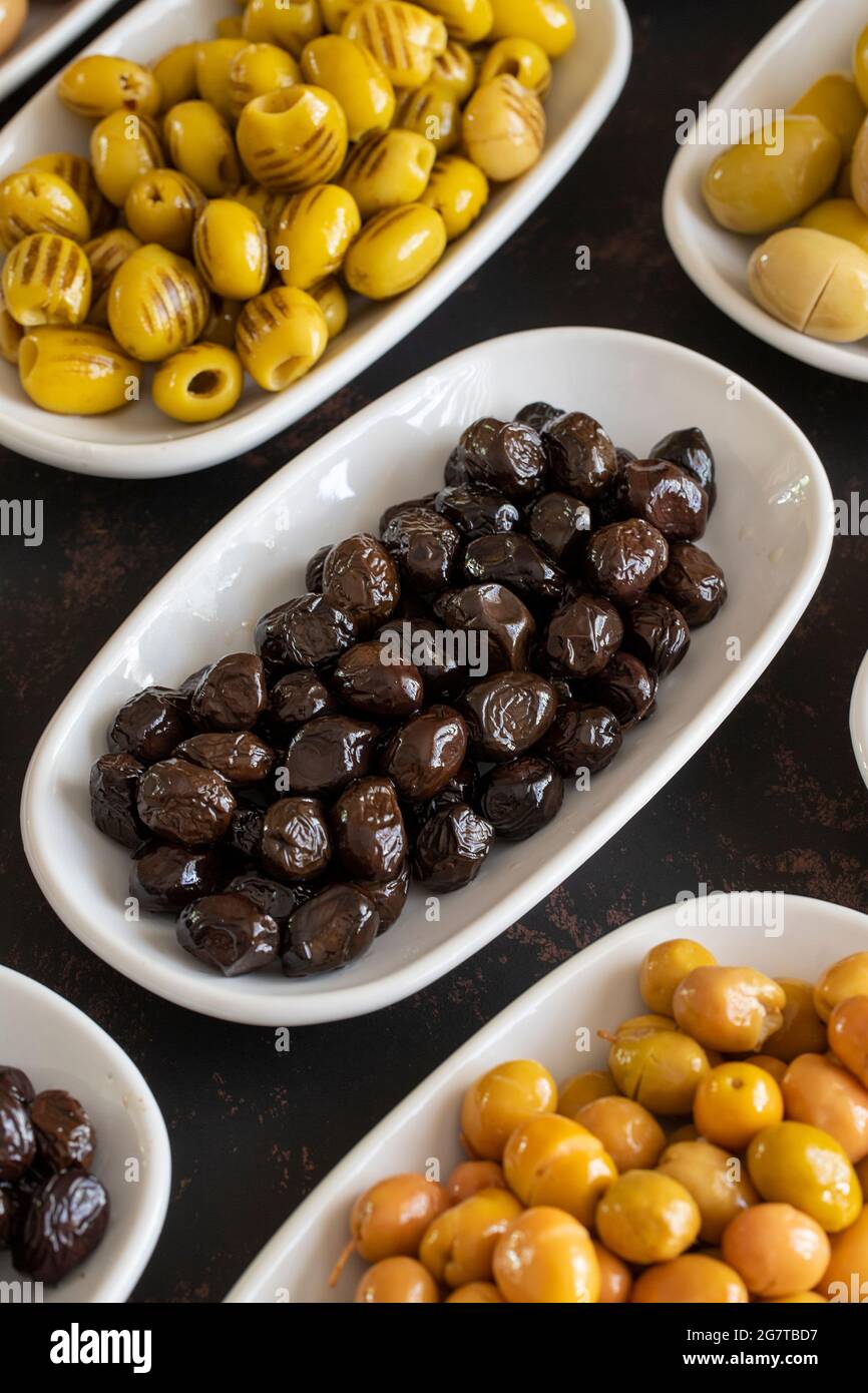 Assortment of olives on the plate in bulk. Organic black olives, Olive ...