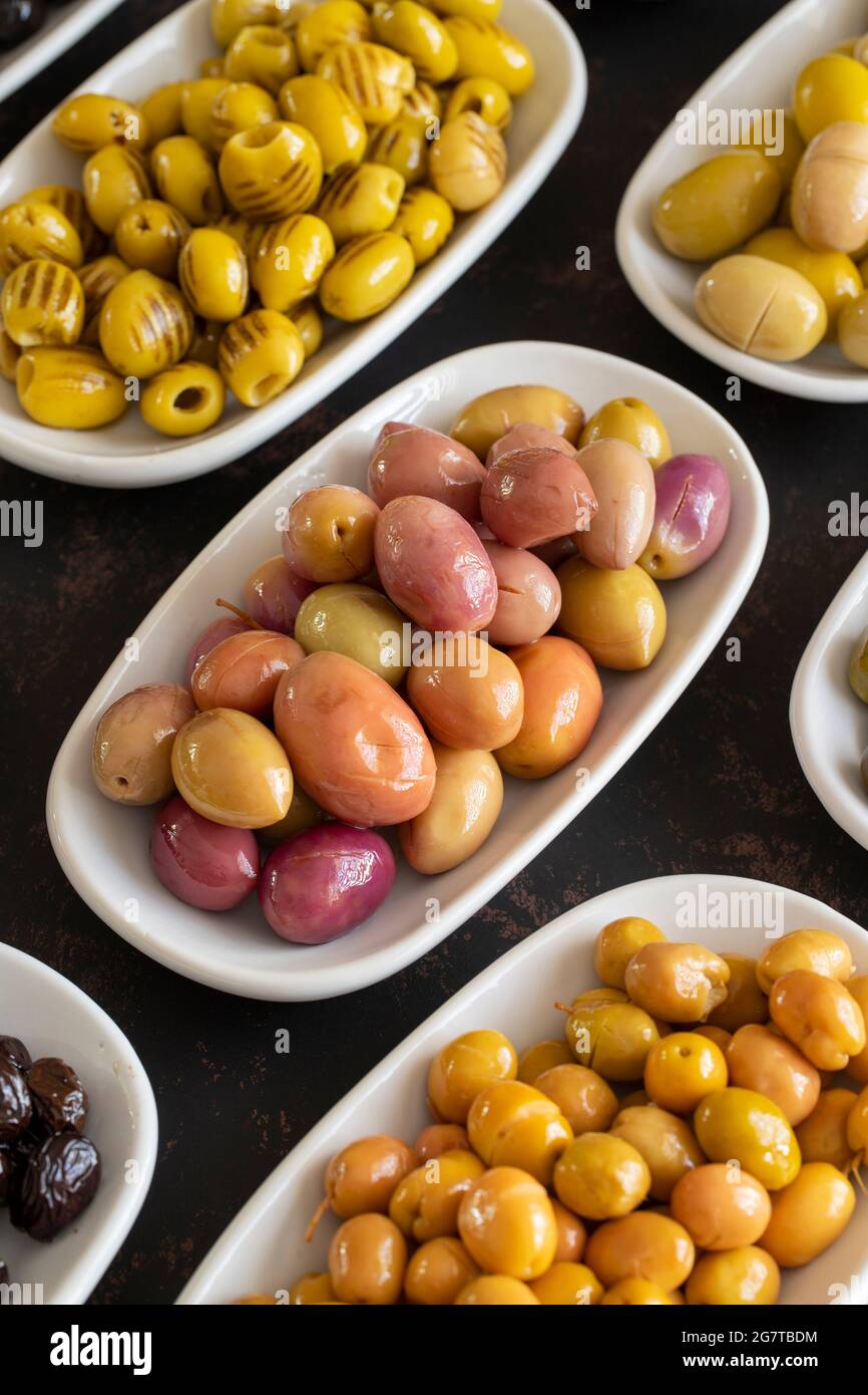 Assortment of olives on the plate in bulk. Organic black olives, Olive ...
