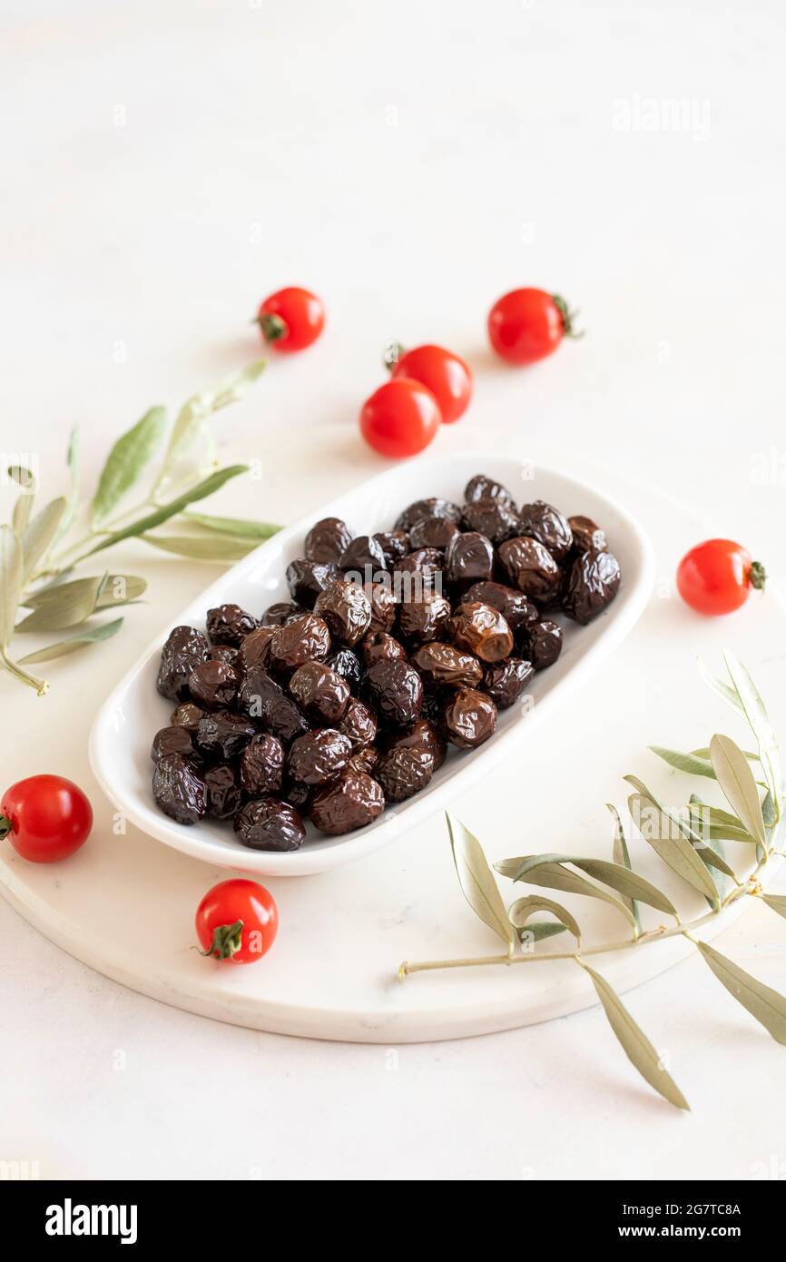 Black olive. Tasty organic black olives in the plate. Olive on marble ...