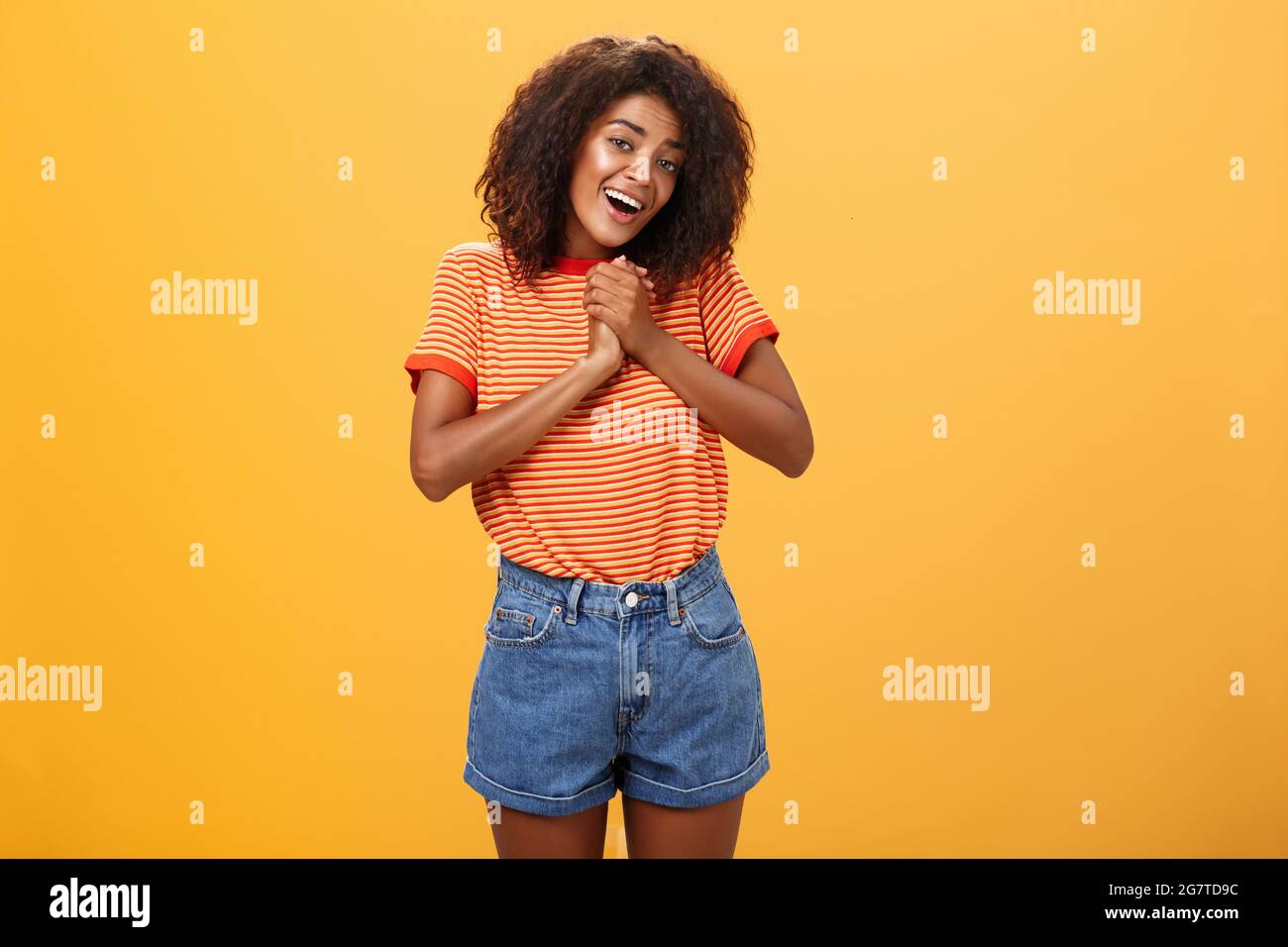 Girl sighing and gazing at cute thing clenching palms together near ...