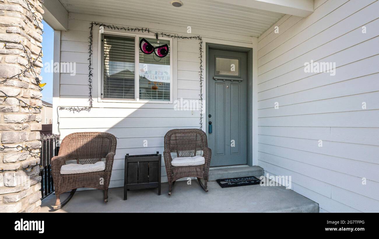 Pano Front porch exterior with stone column post and seasonal ...