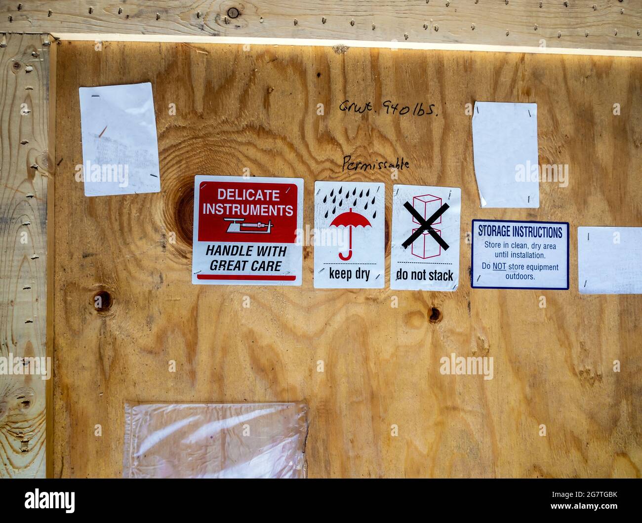 warning label beside transportation wooden box Stock Photo - Alamy