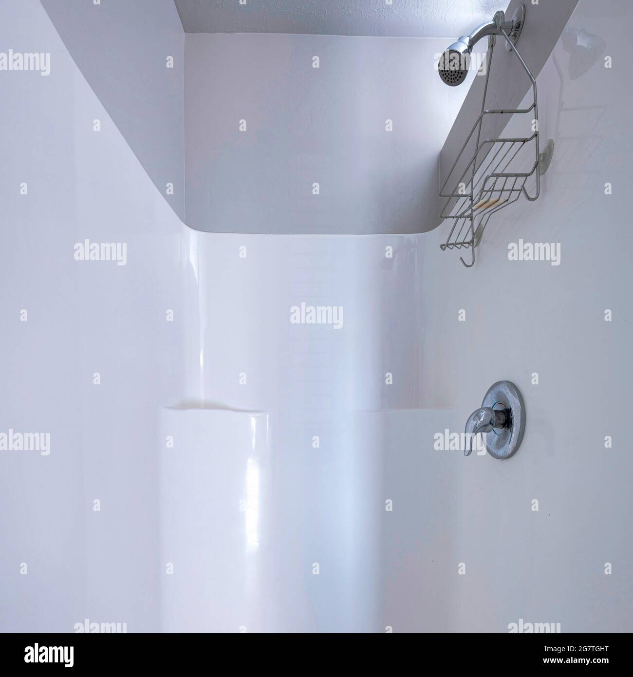 Square frame Shower area with a knob and rack under the shower head ...