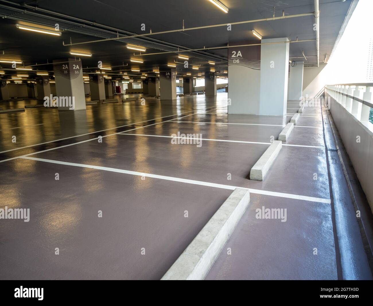 Clean and glossy flooring of the Parking lot in the parking building ...