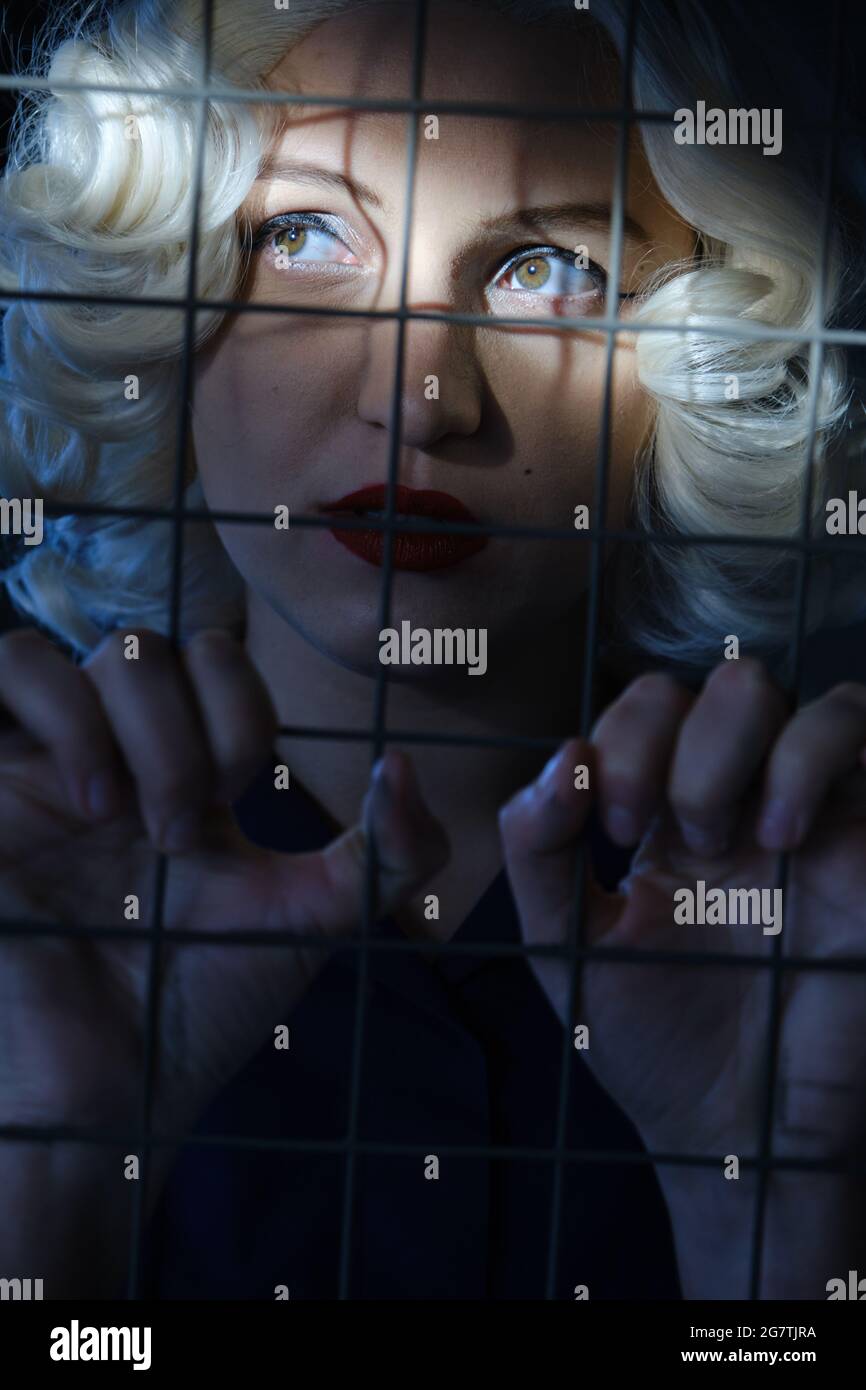 sad scared blonde behind bars close up portrait Stock Photo - Alamy