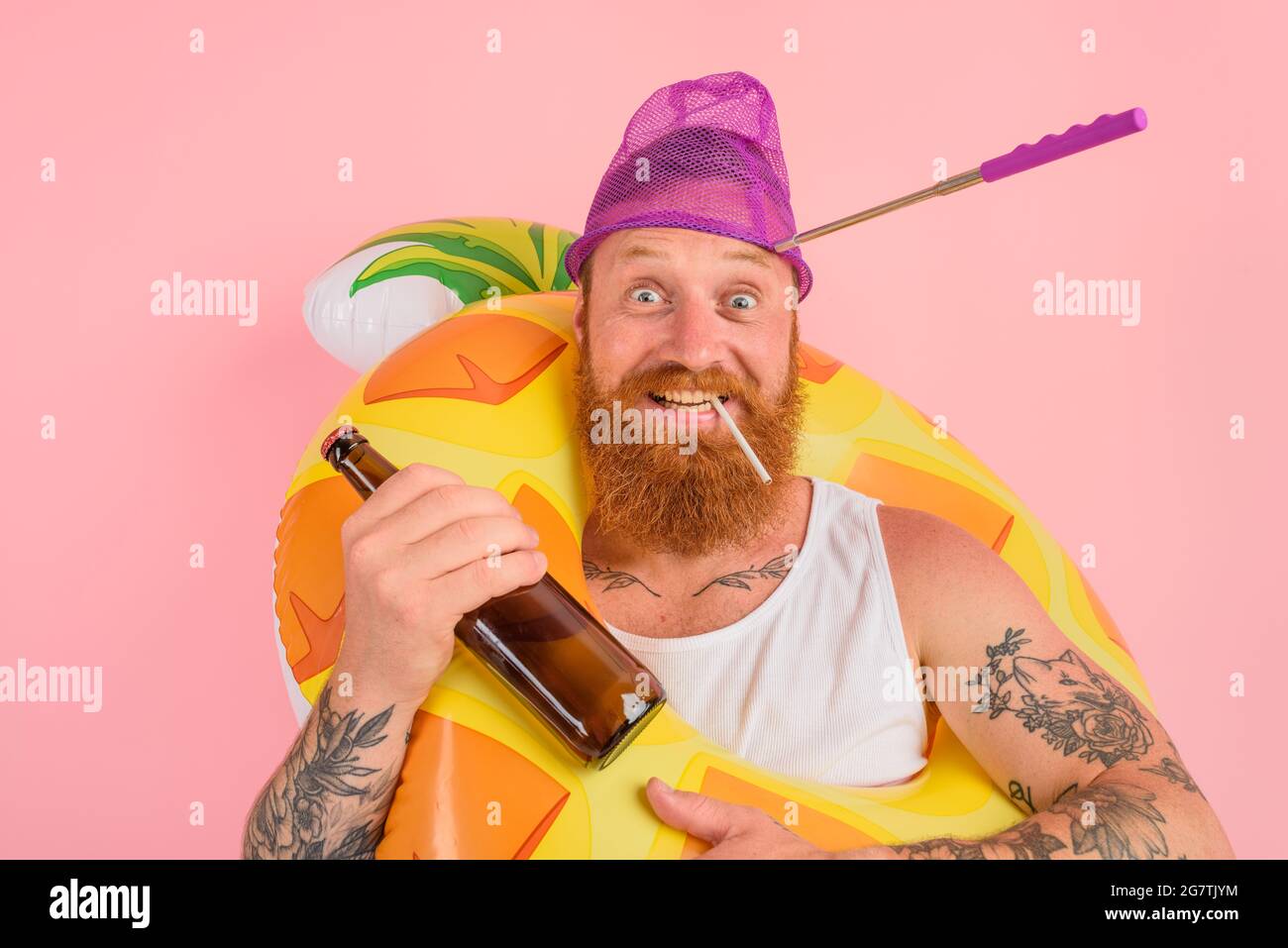 Happy man is ready to swim with a donut lifesaver with beer and ...