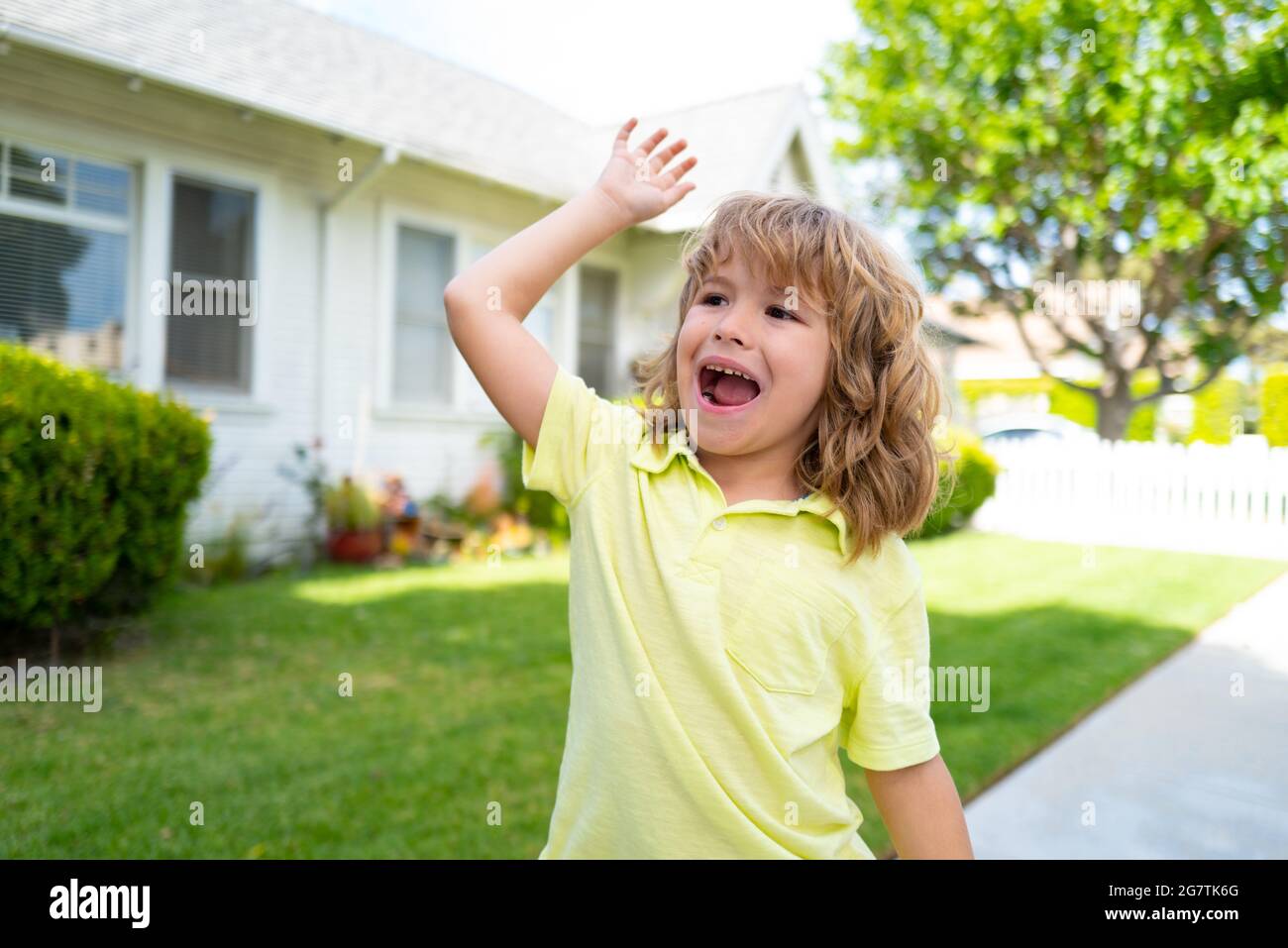 Boy with good bye or hello sign outdoor. Kids with funny face bye bye ...