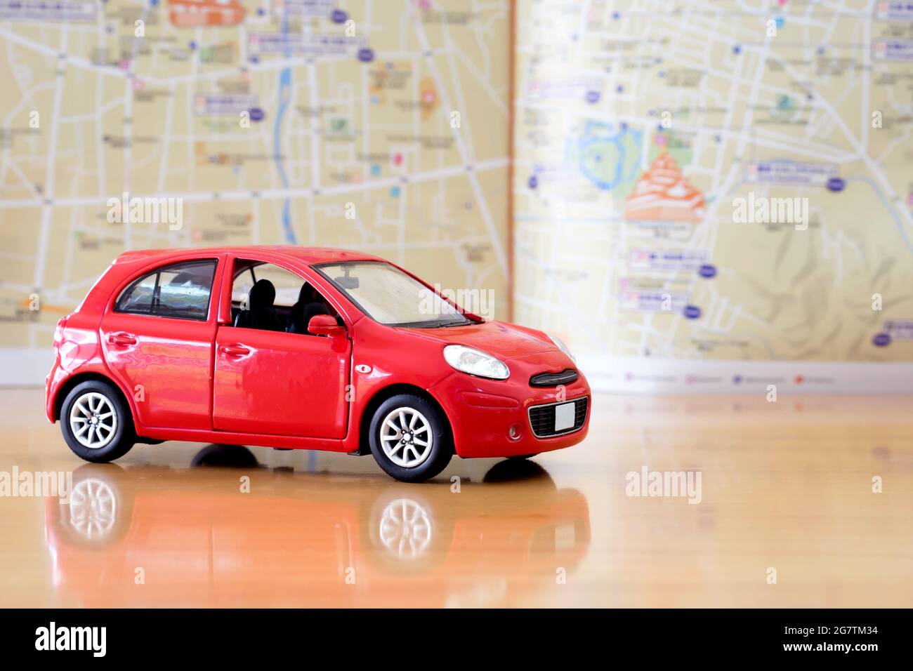 Toy red car on vacation Stock Photo - Alamy