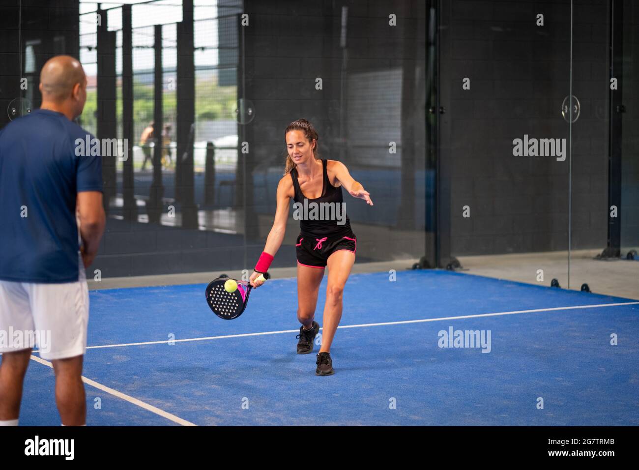 Monitor teaching padel class to woman, his student - Trainer teaches ...