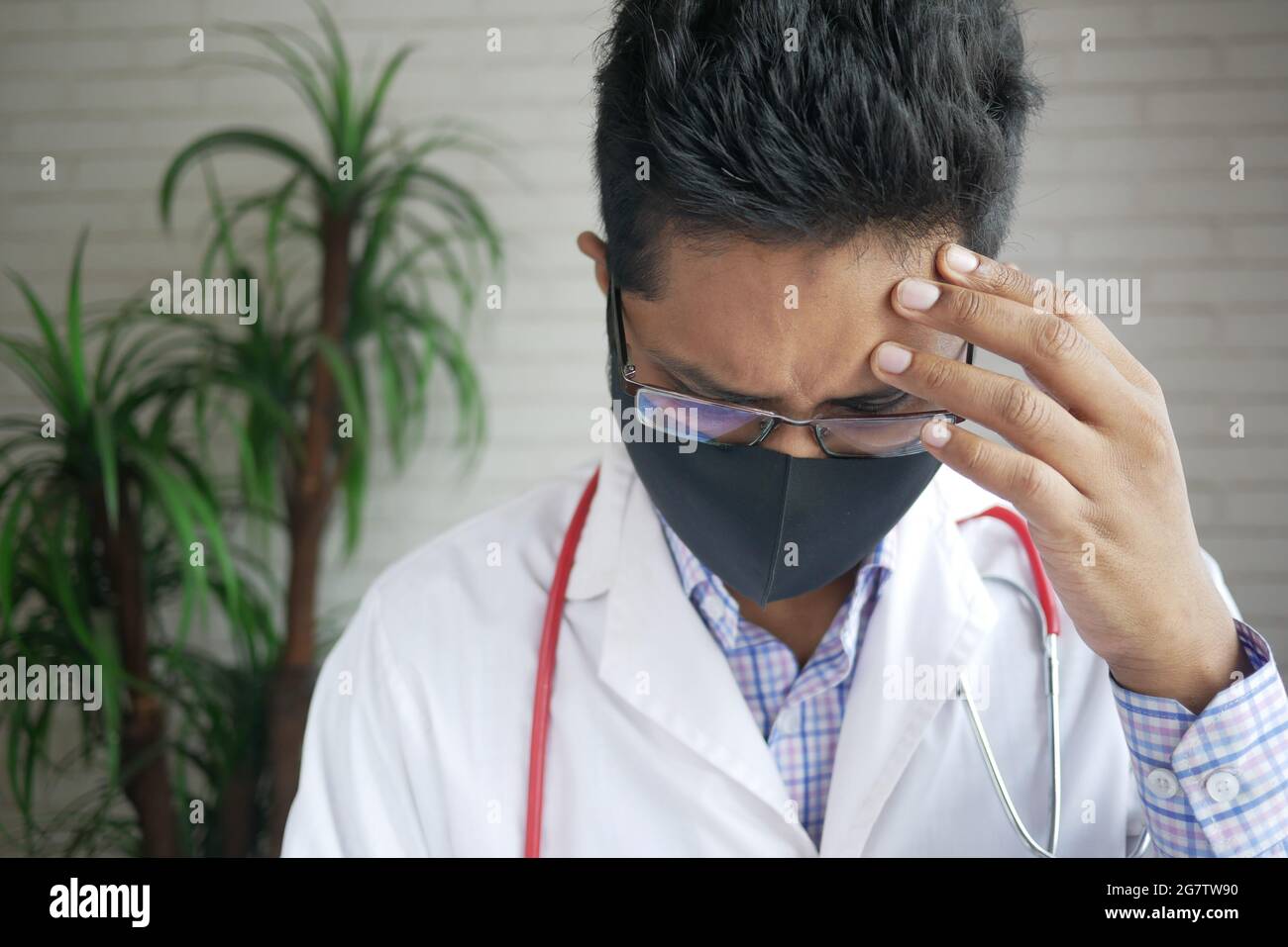 Depressed sad doctor covering face with hands Stock Photo - Alamy