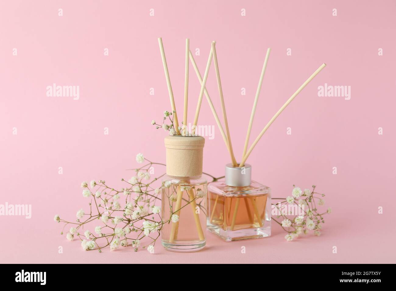 Aromatic concept with diffusers on pink background Stock Photo - Alamy